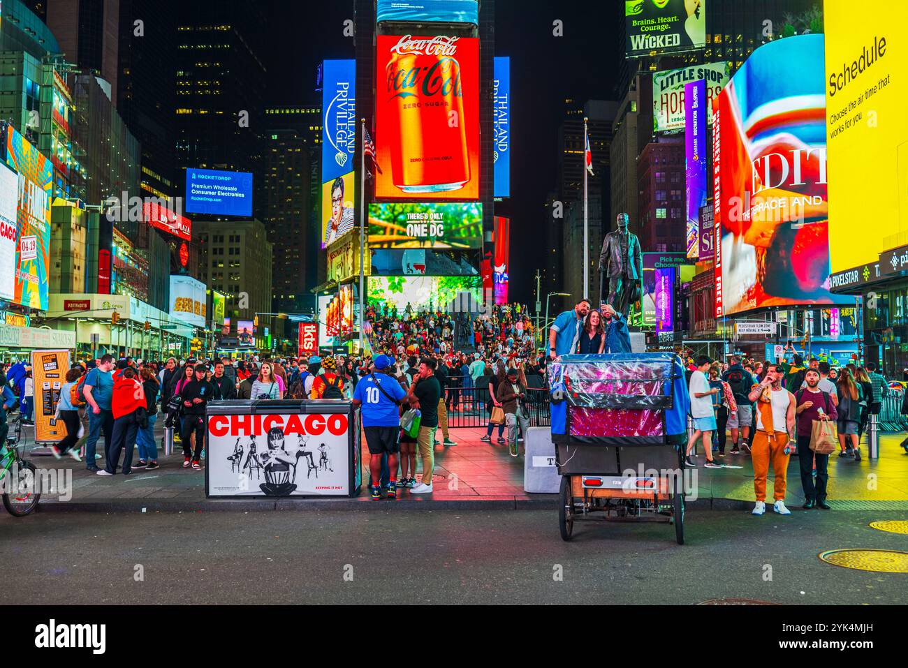 Vibrant Times Square at night with illuminated billboards, crowds of ...