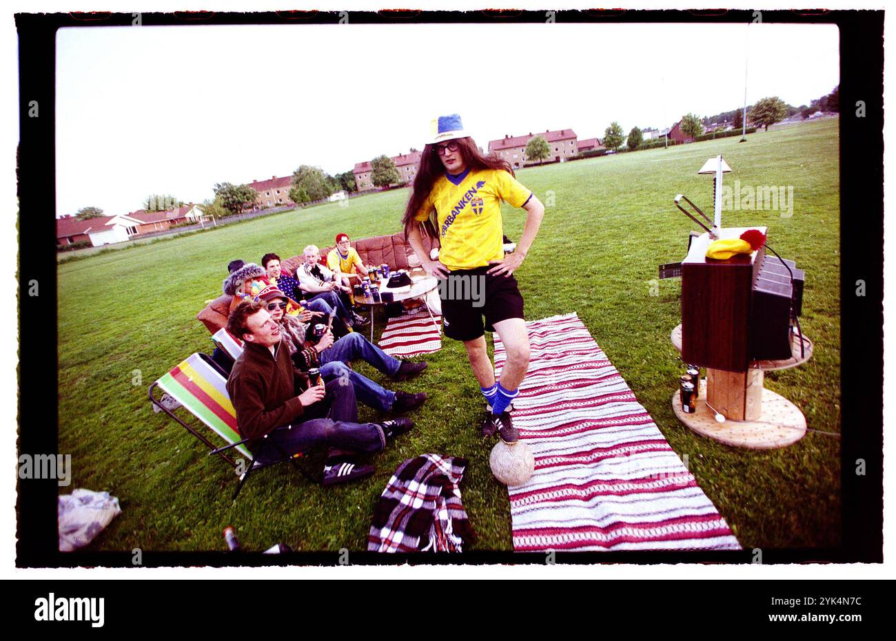 Swedish football fans who have moved the sofa and TV out onto a ...