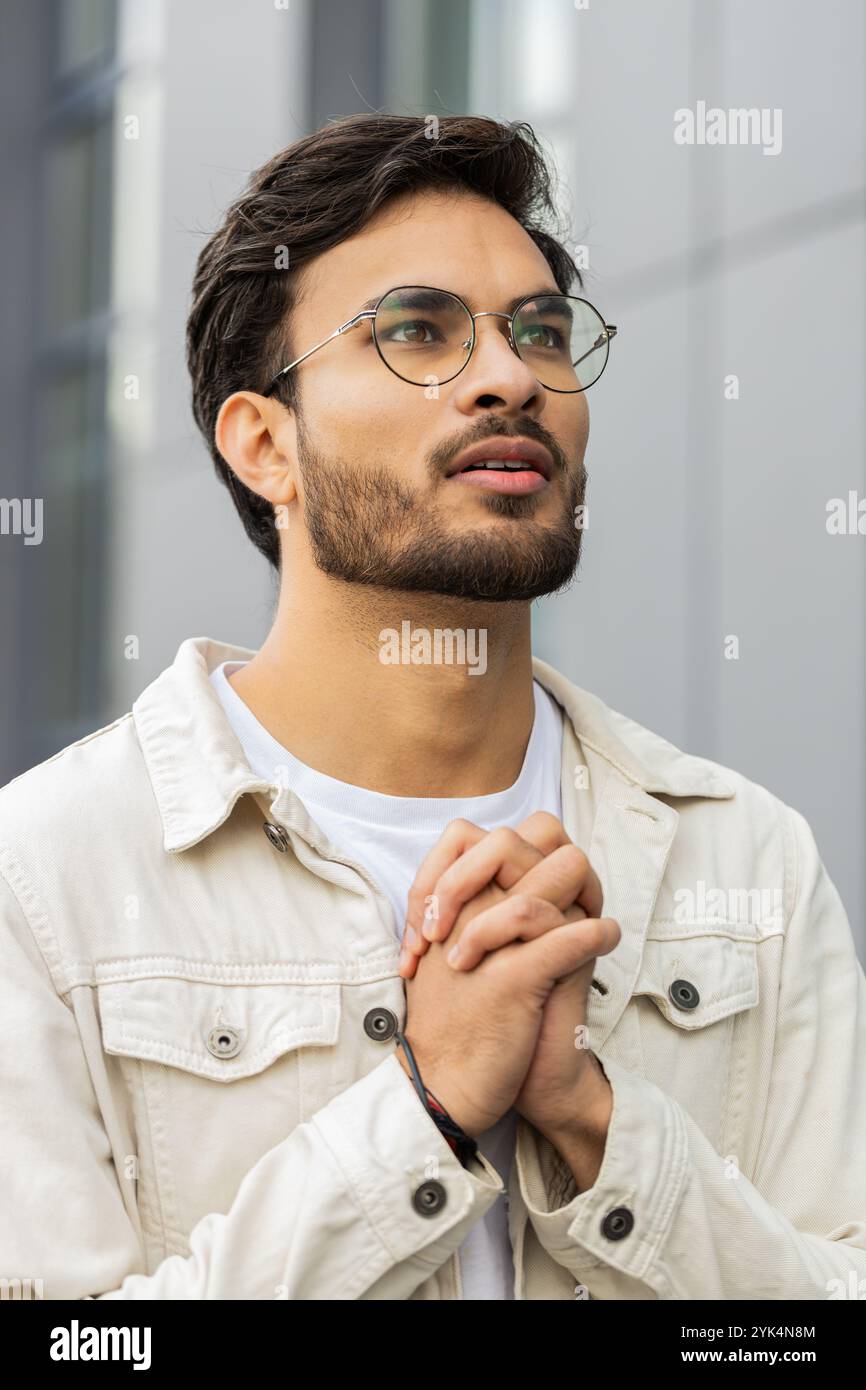 Indian man praying with closed eyes to God asking for blessing, help ...