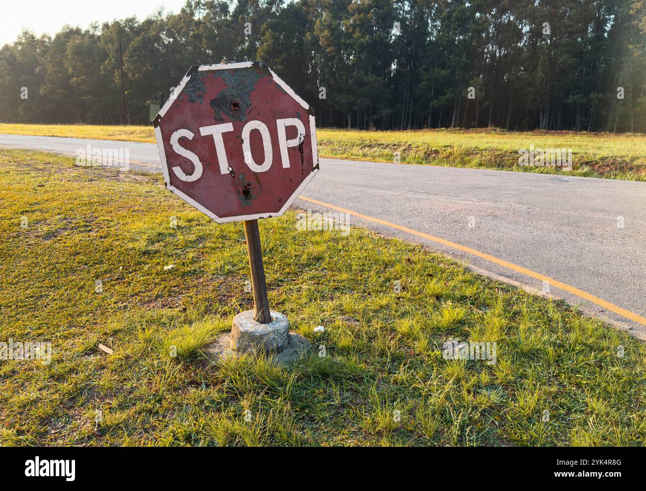 Stop road sign at the roadside, Old traffic warning sign by an empty ...
