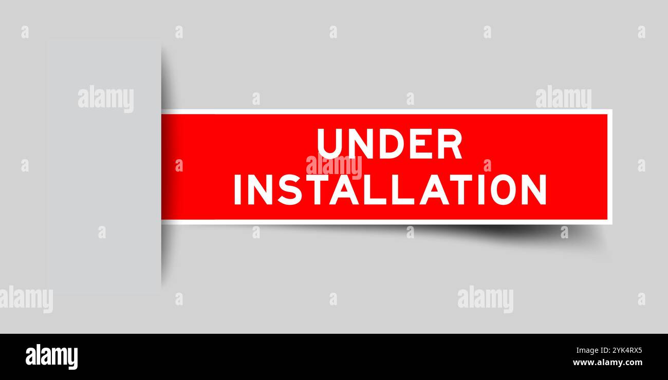 Red color square label sticker with word under installation that ...