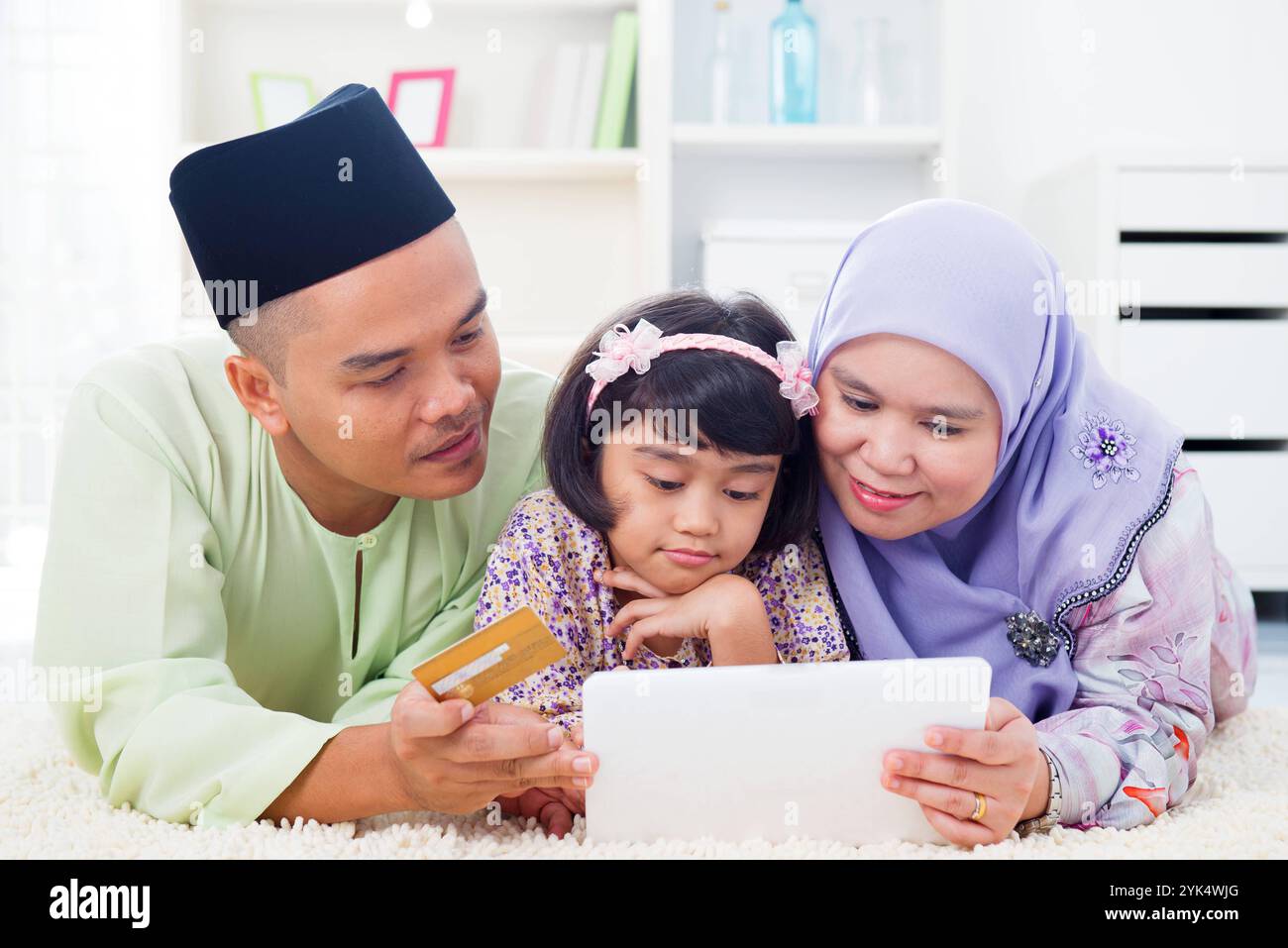 Asian family online shopping Southeast Asian family using tablet pc ...