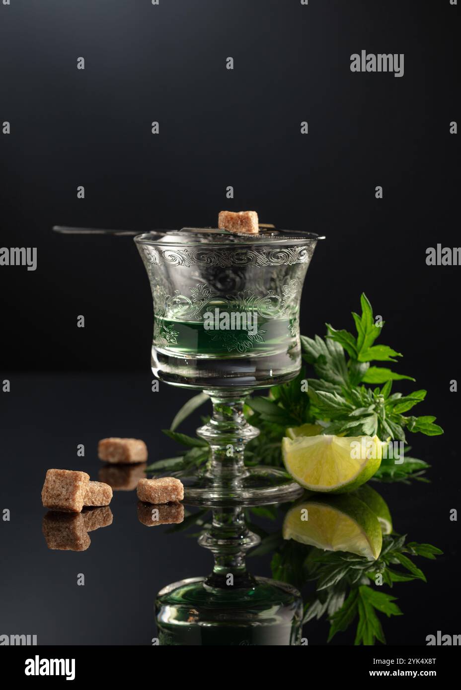 Glass of absinthe with ingredients on a black background. Absinthe ...