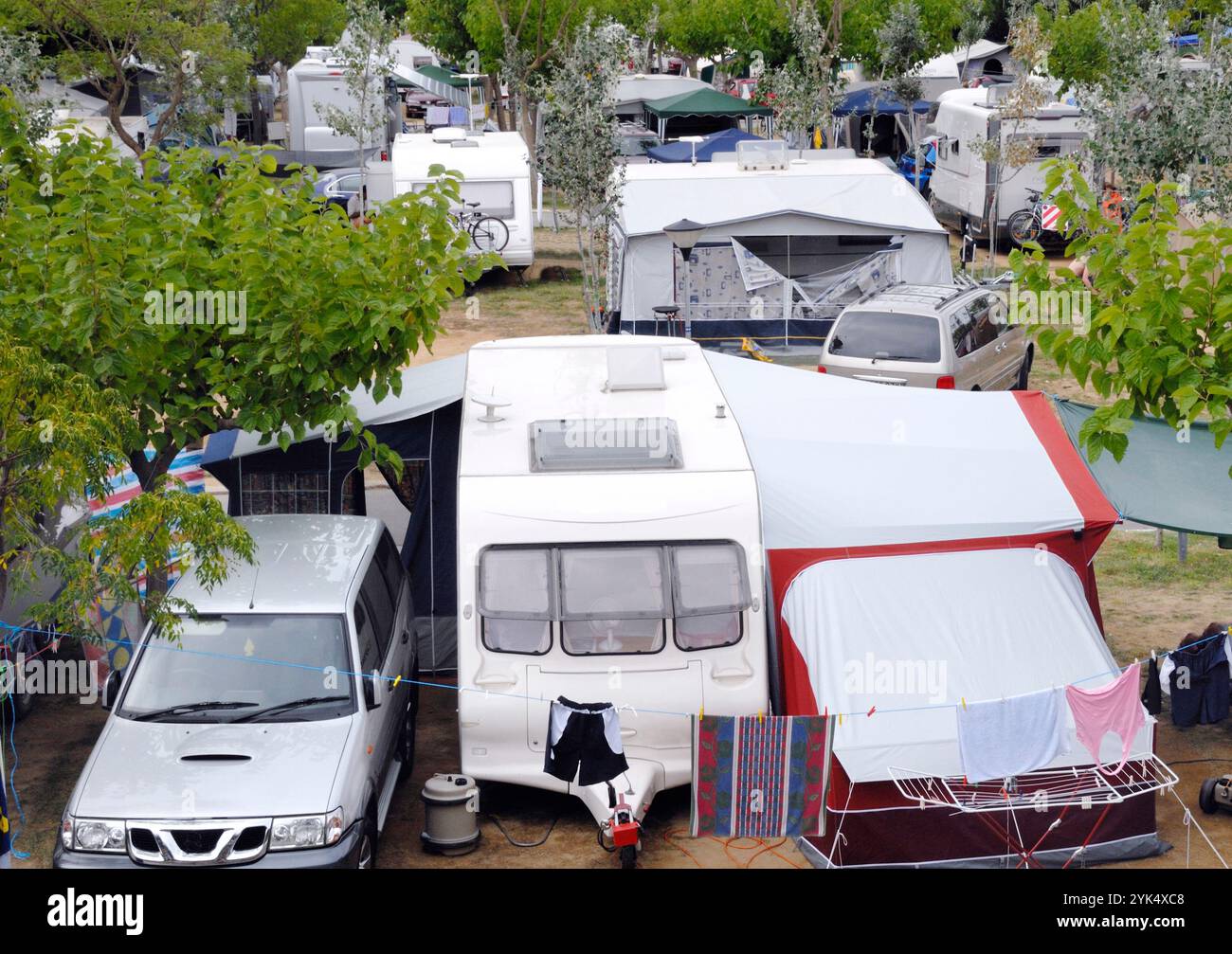 Overview of a crowded camping in Spain with tents, motorhomes and ...