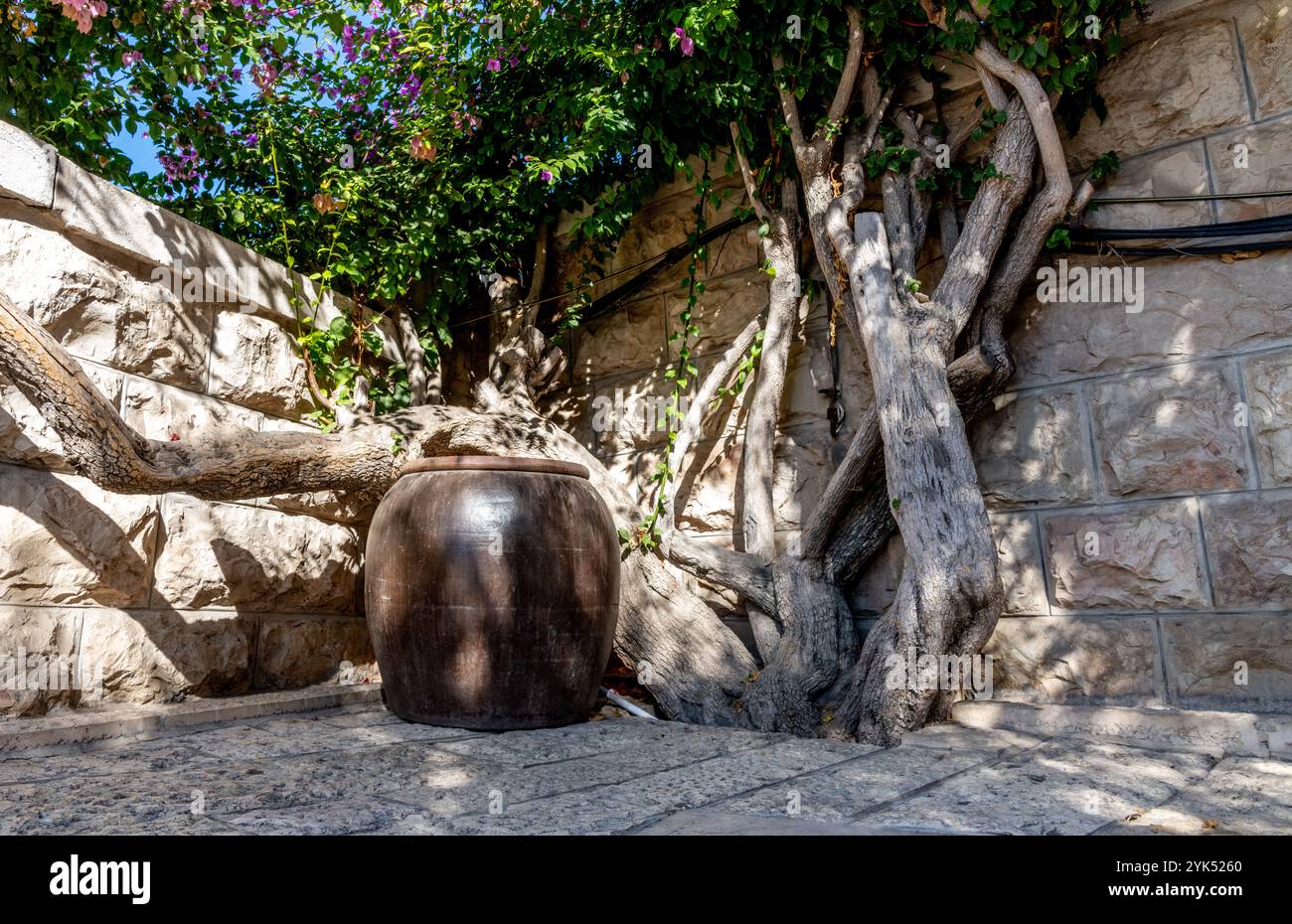 Large brown urn and stone walls at the Garden of Gethsemane in ...