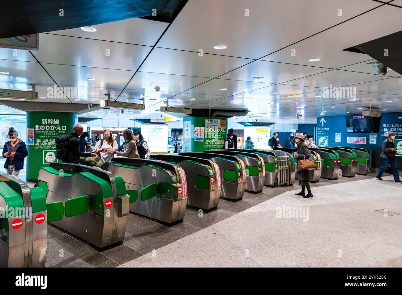 Commuters at a row of ticket barrier machines for the northern bound ...