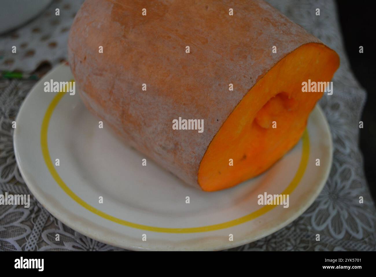 Healthy, wholesome food. Half of an orange tavern is lying on a clay ...