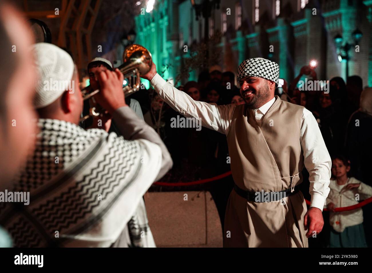 People wearing folkloric costumes dance during the Baghdad Day Festival ...