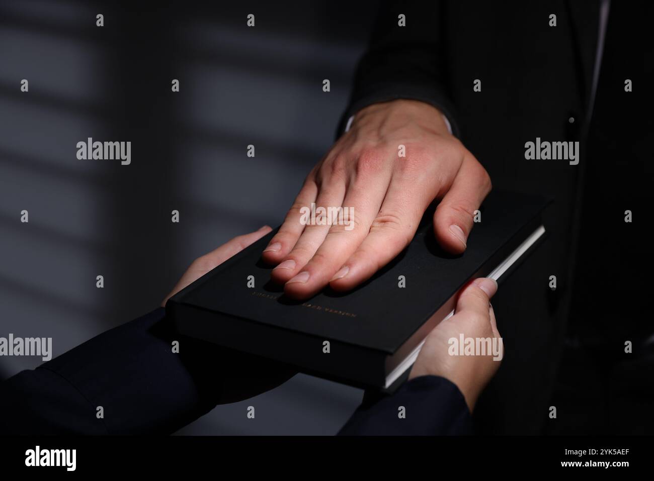 Man taking oath with his hand on Bible indoors, closeup Stock Photo - Alamy