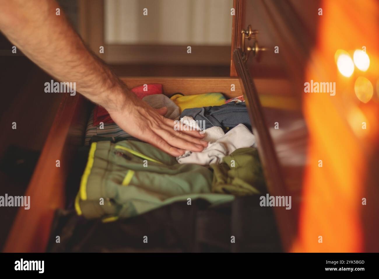 A man puts his things on a shelf Stock Photo - Alamy