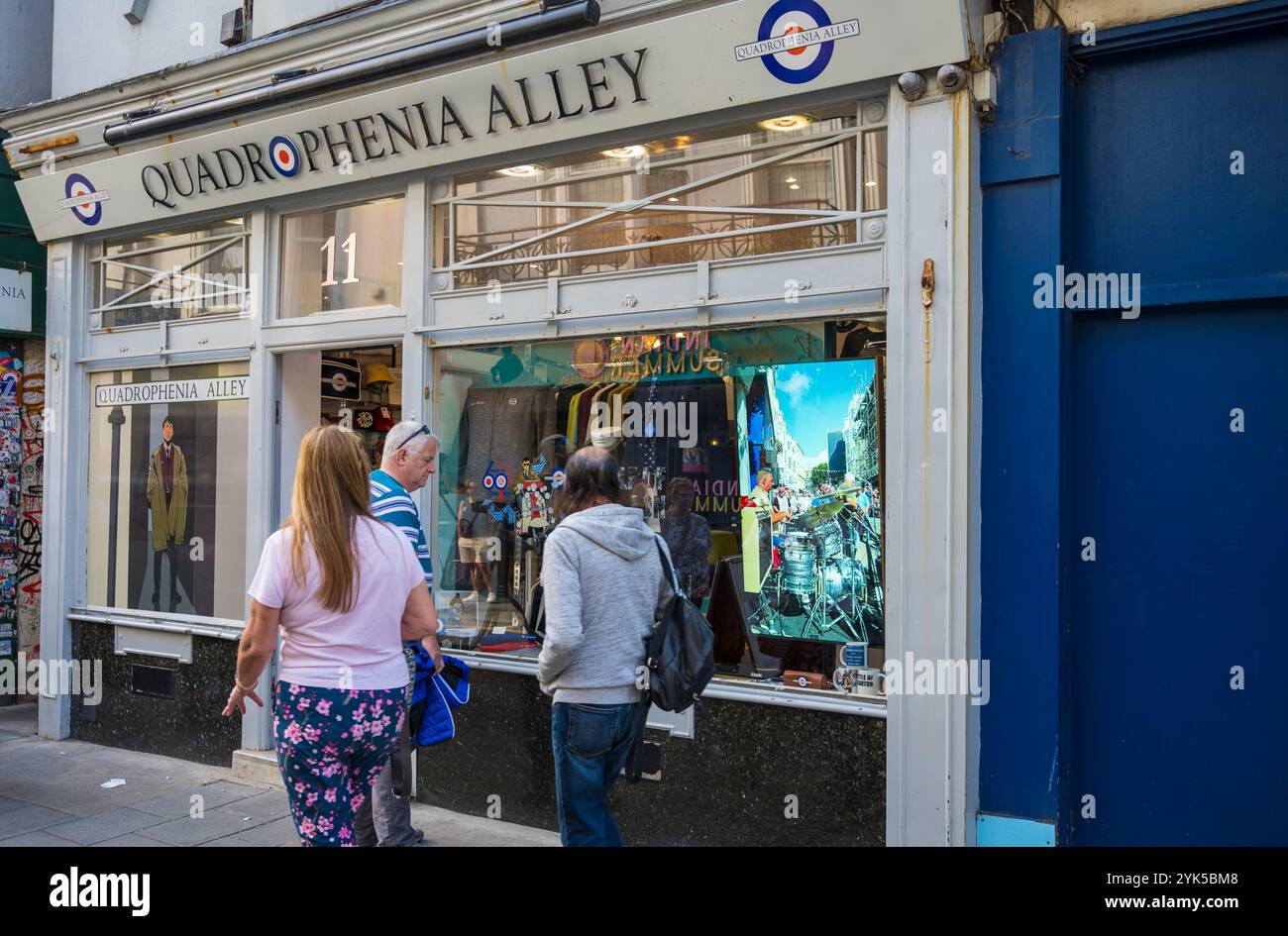 People looking in shopfront window of Quadrophenia Alley a men's ...
