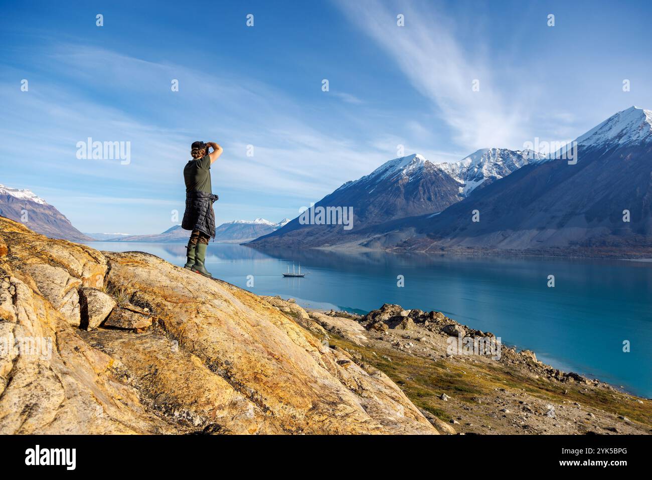 Man photographs the fjords and mountains of Greenland, with schooner ...