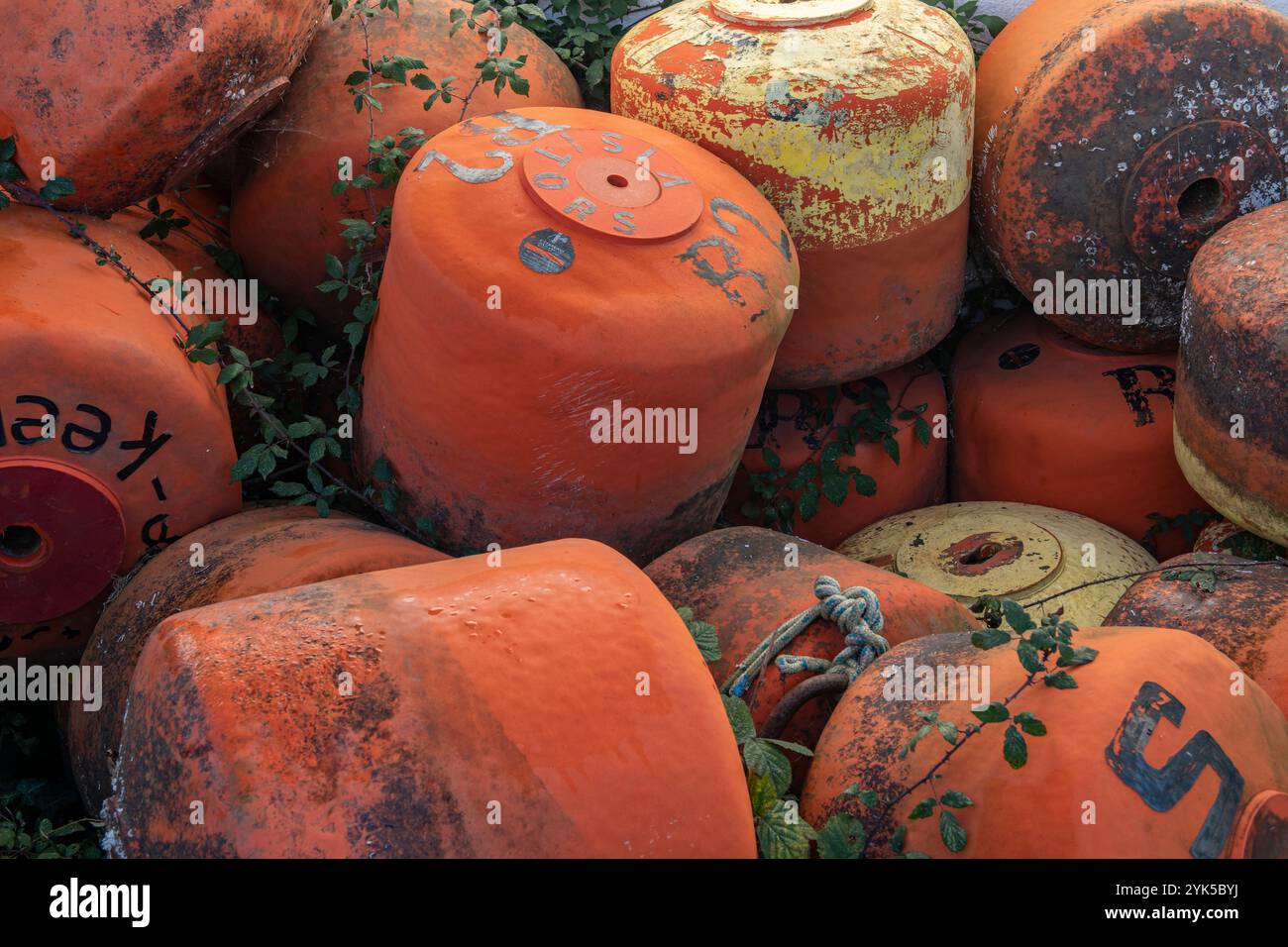 abstract image of a pile of orange mooring or marker floats and buoys ...