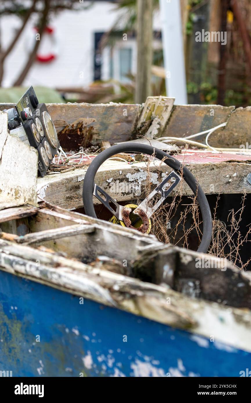 the wreck of an old speedboat left to rot or abandoned on a beach on ...