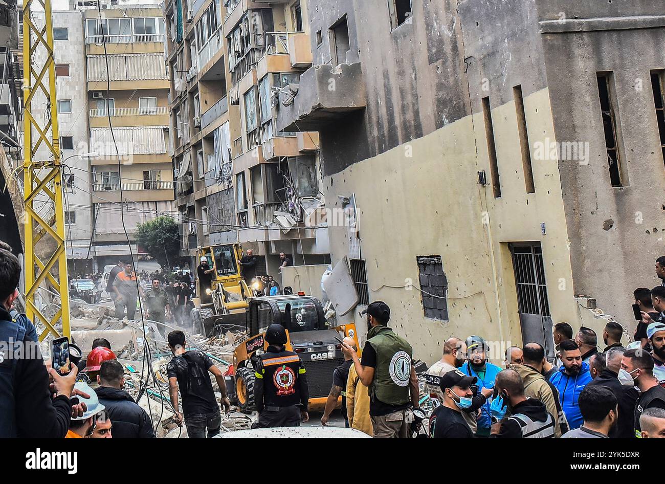 Beirut, Lebanon. 17th Nov, 2024. Residents and rescuers gather in front of a building targeted ...
