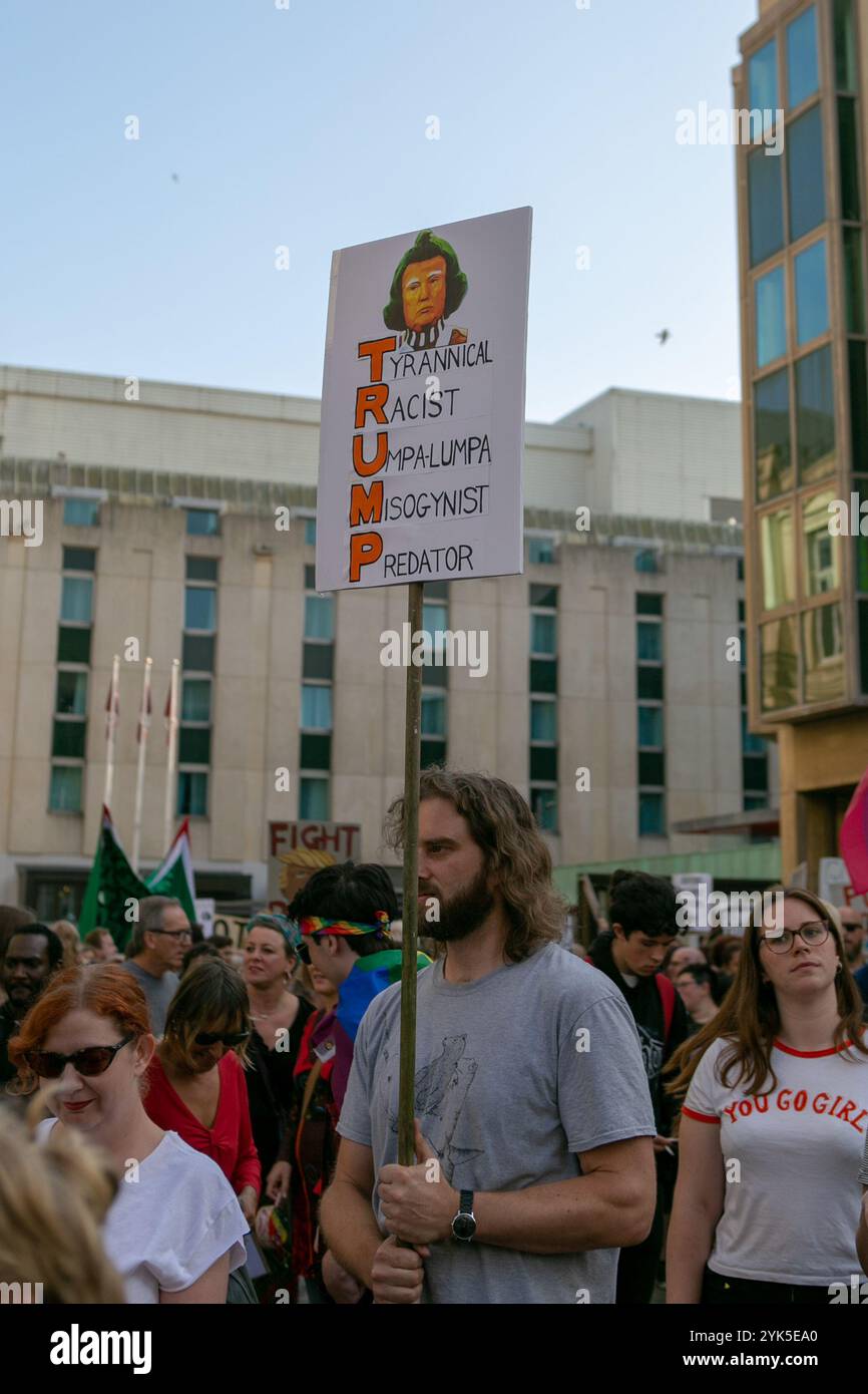 Hundreds of people holding anti-Trump placards and banners gathered ...