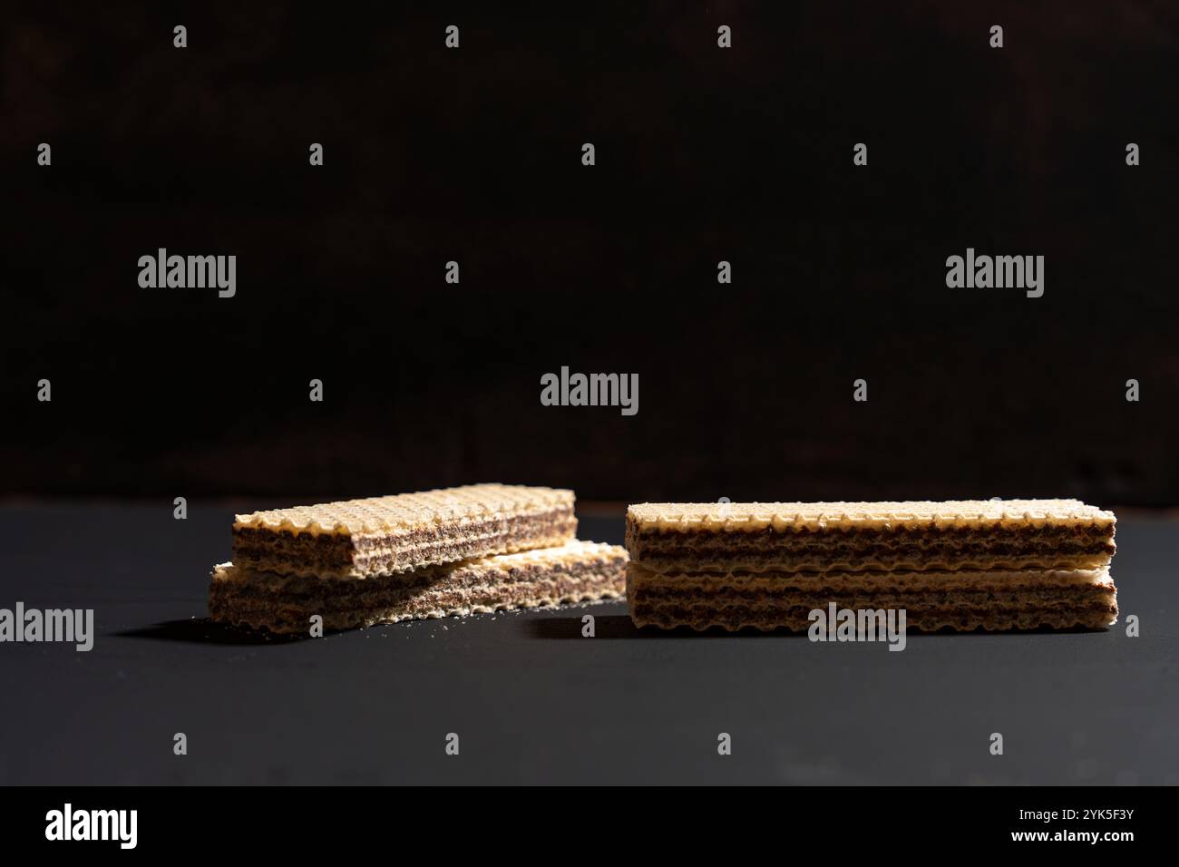 A stack of wafers on a dark background. The wafers are stacked in a ...