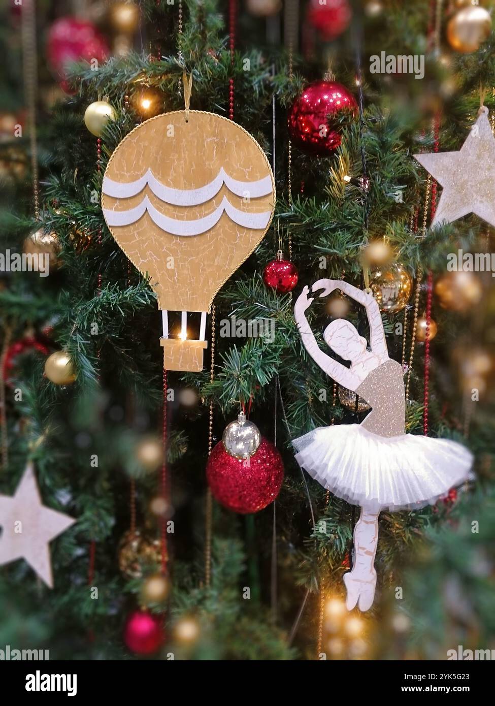 The Christmas tree is decorated with a golden ball and a white ...