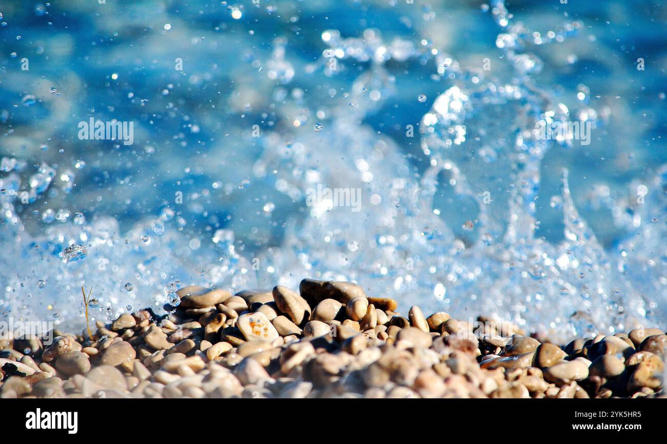 Detail of a Wave Breaking on Pebbles: Focus on Beach Details. details ...