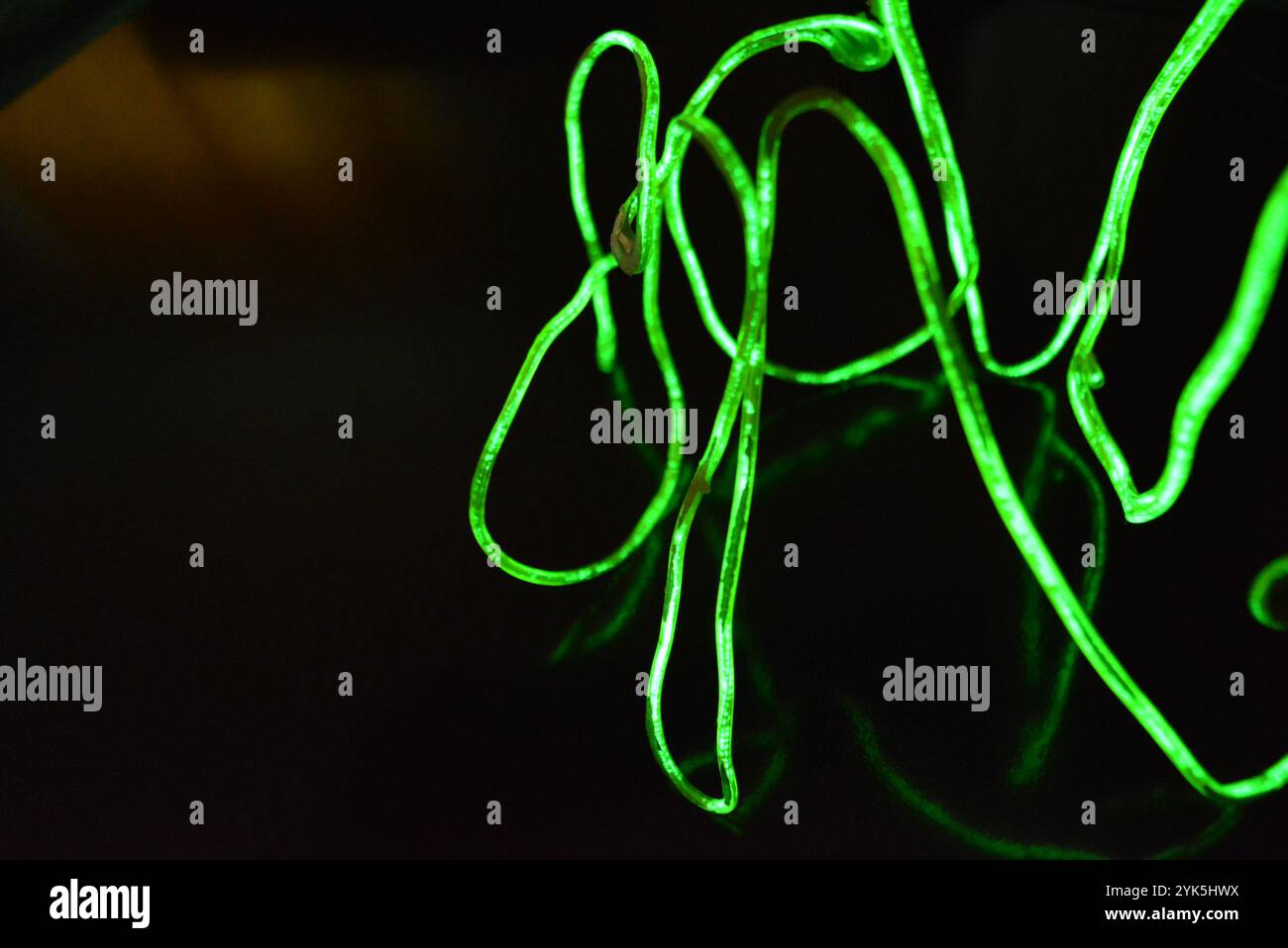 Beautiful thin glowing green, lime wires, beaten cable chaotically ...