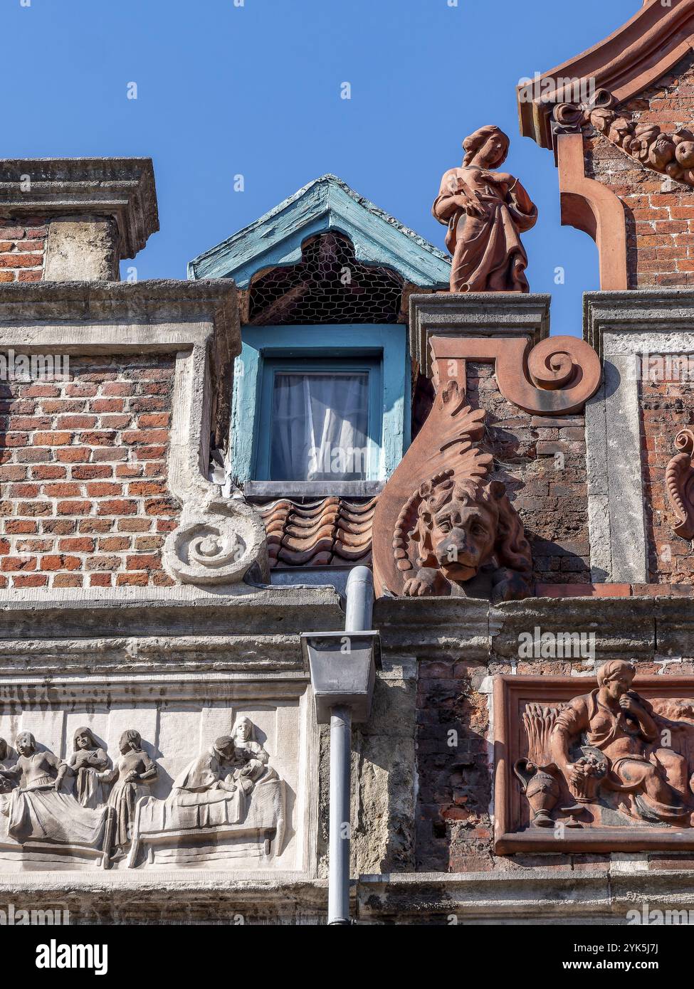 Roof detail with rich relief, sculpture and window of two medieval ...