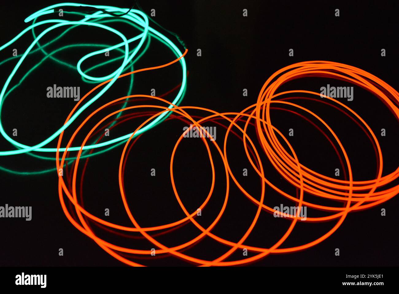 Unusual glowing blue and red thread, twisting wire, structural and ...