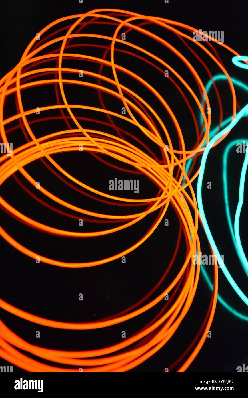 Unusual glowing blue and red thread, twisting wire, structural and ...