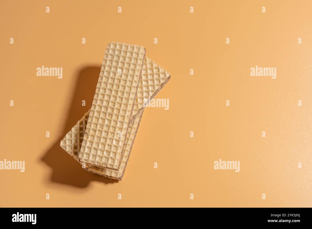 A stack of wafers on a table. The wafers are white and have a square ...