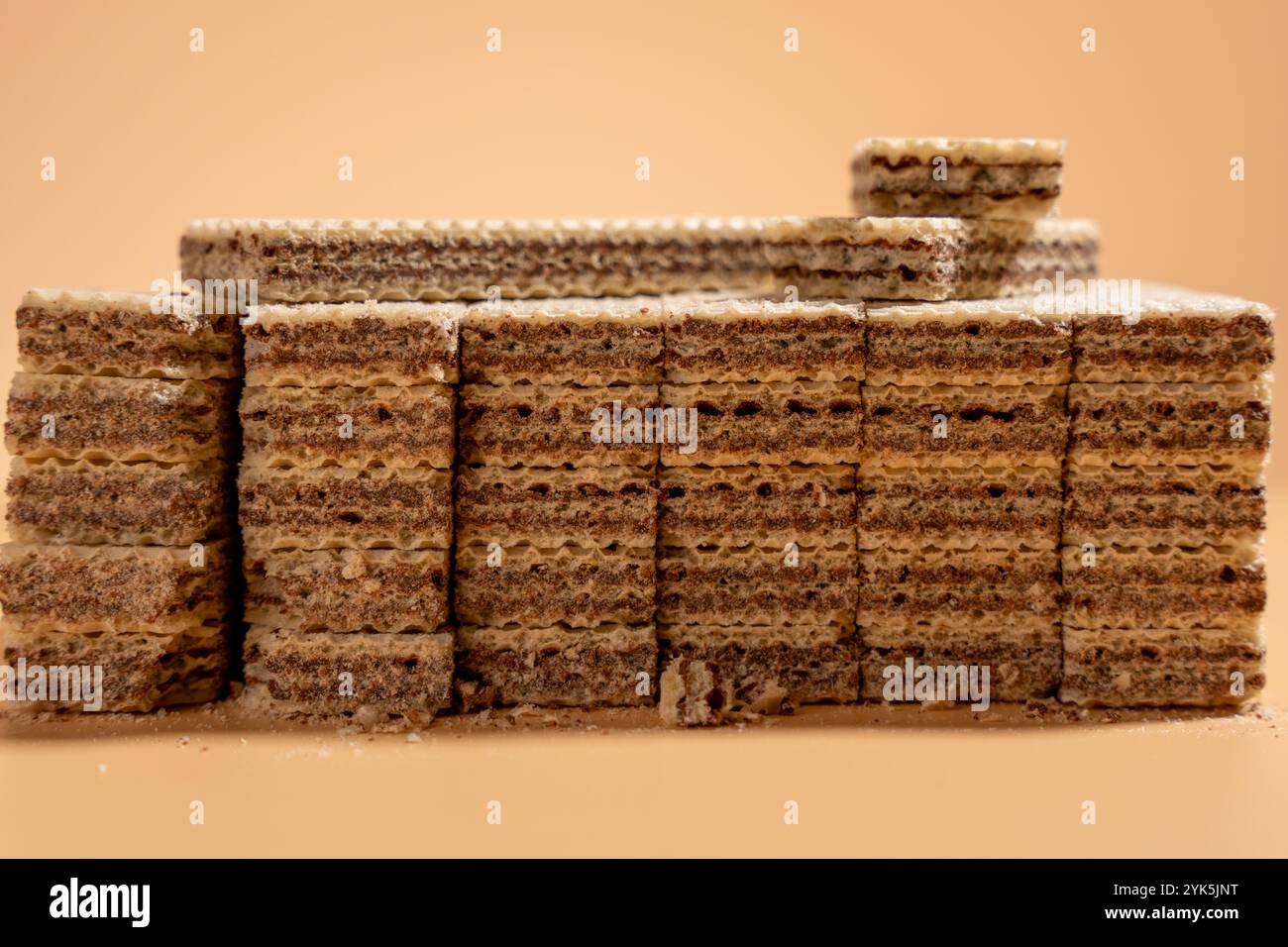 A stack of wafers with a brownish color. The wafers are piled up on top ...