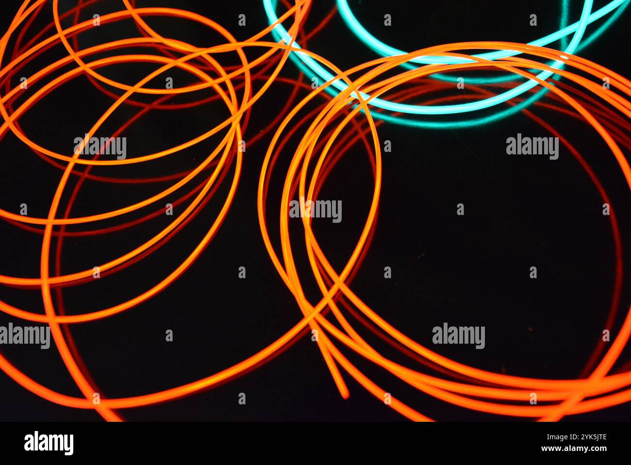 Unusual glowing blue and red thread, twisting wire, structural and ...