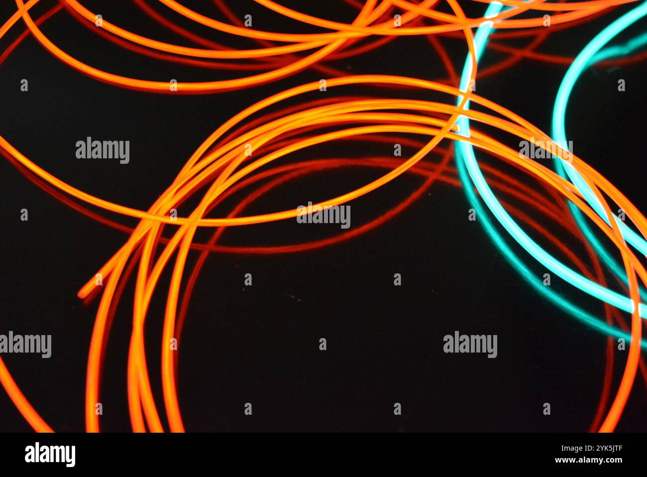 Unusual glowing blue and red thread, twisting wire, structural and ...