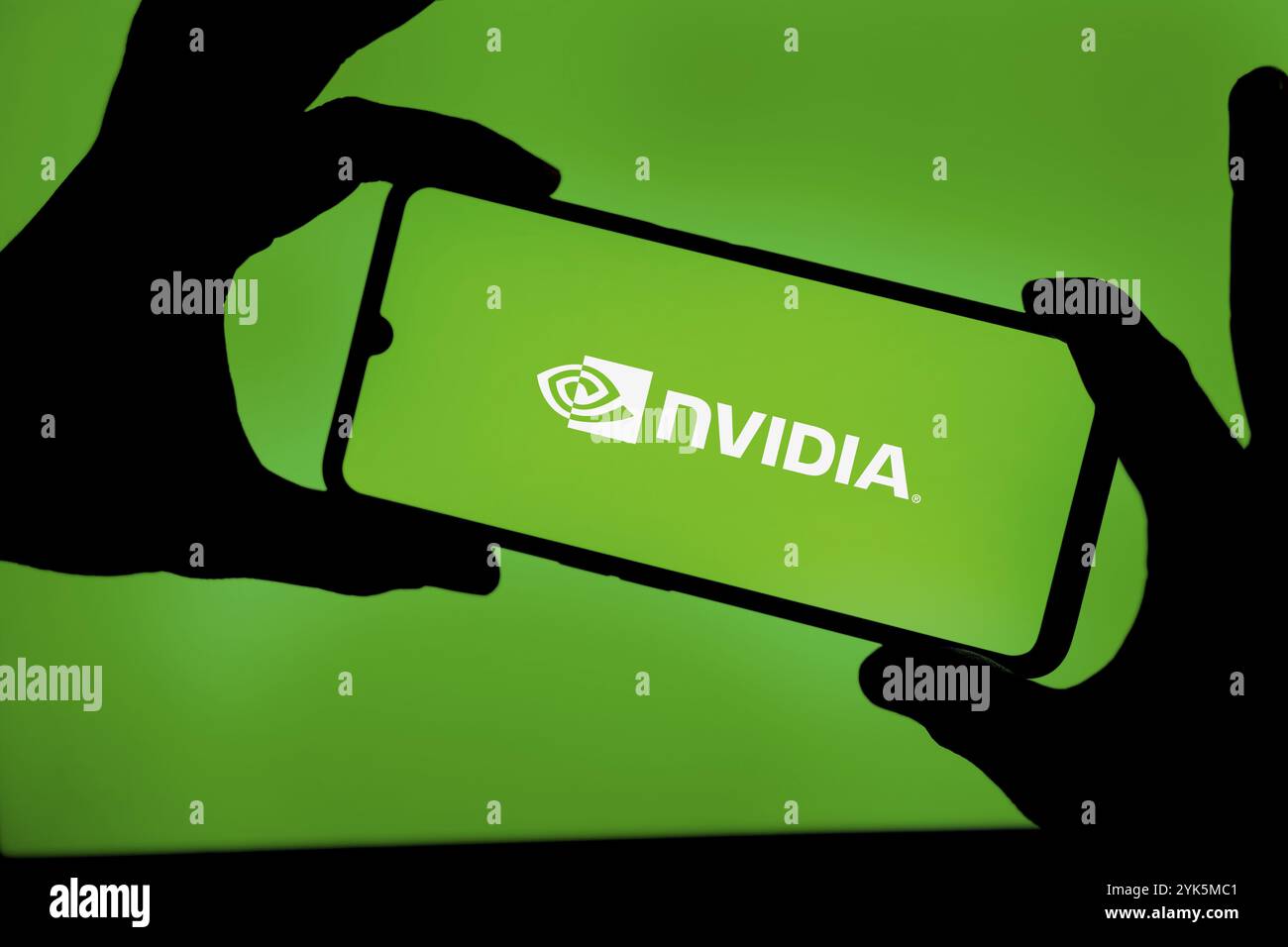 Nvidia logo on smartphone screen with AI in the background. Nvidia ...