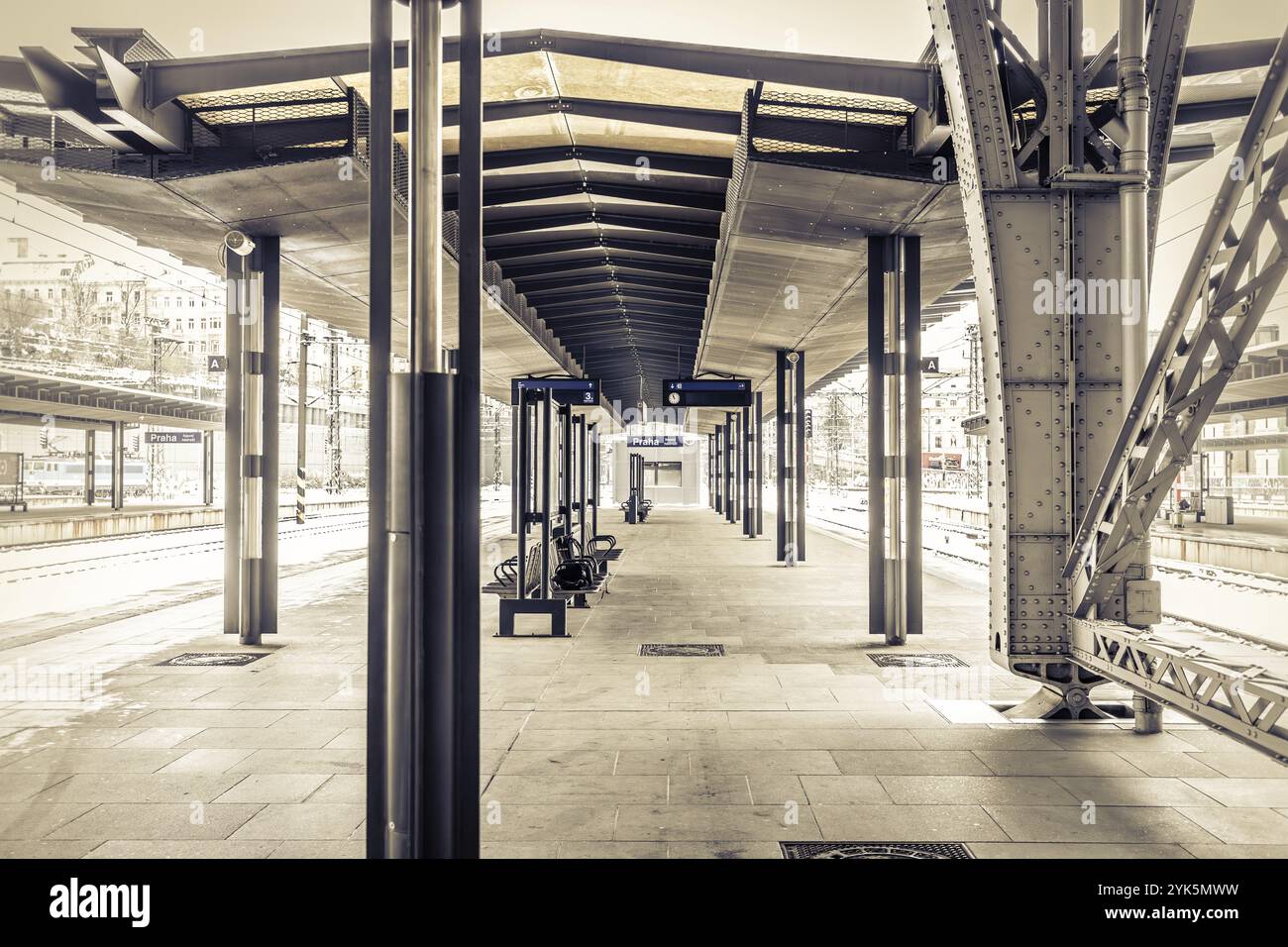 Covered platform in an empty modern railway station in sepia colour ...