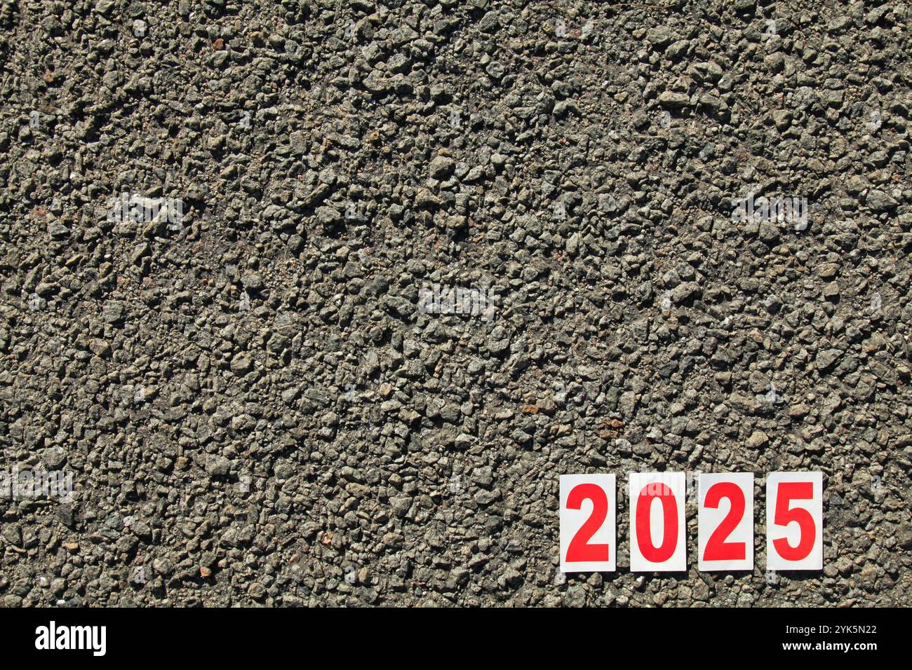 Numbers of 2025 year. Paper square numbers on the stone road background ...