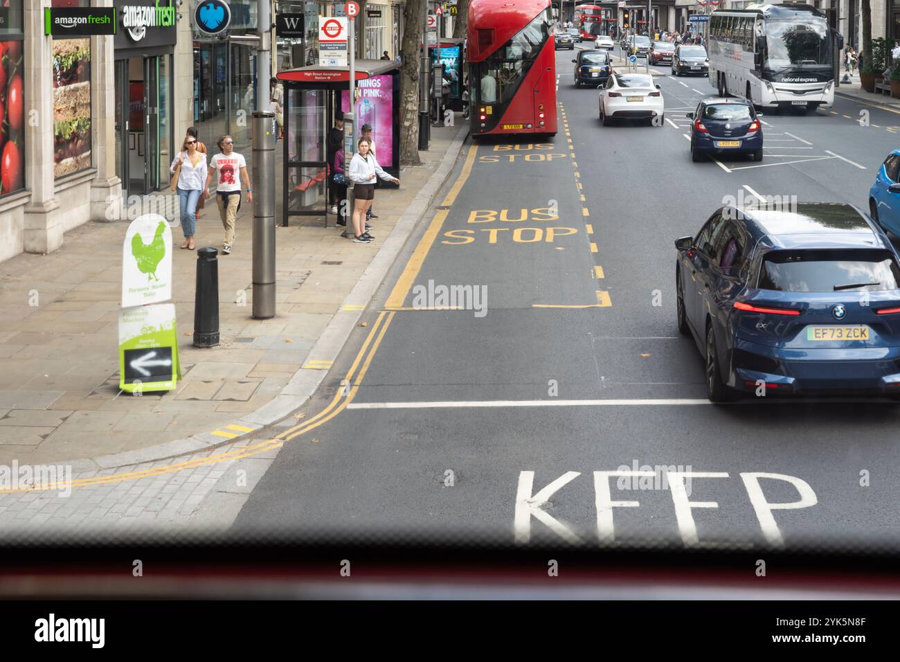 Looking down from the top of a double decker red bus in London ...