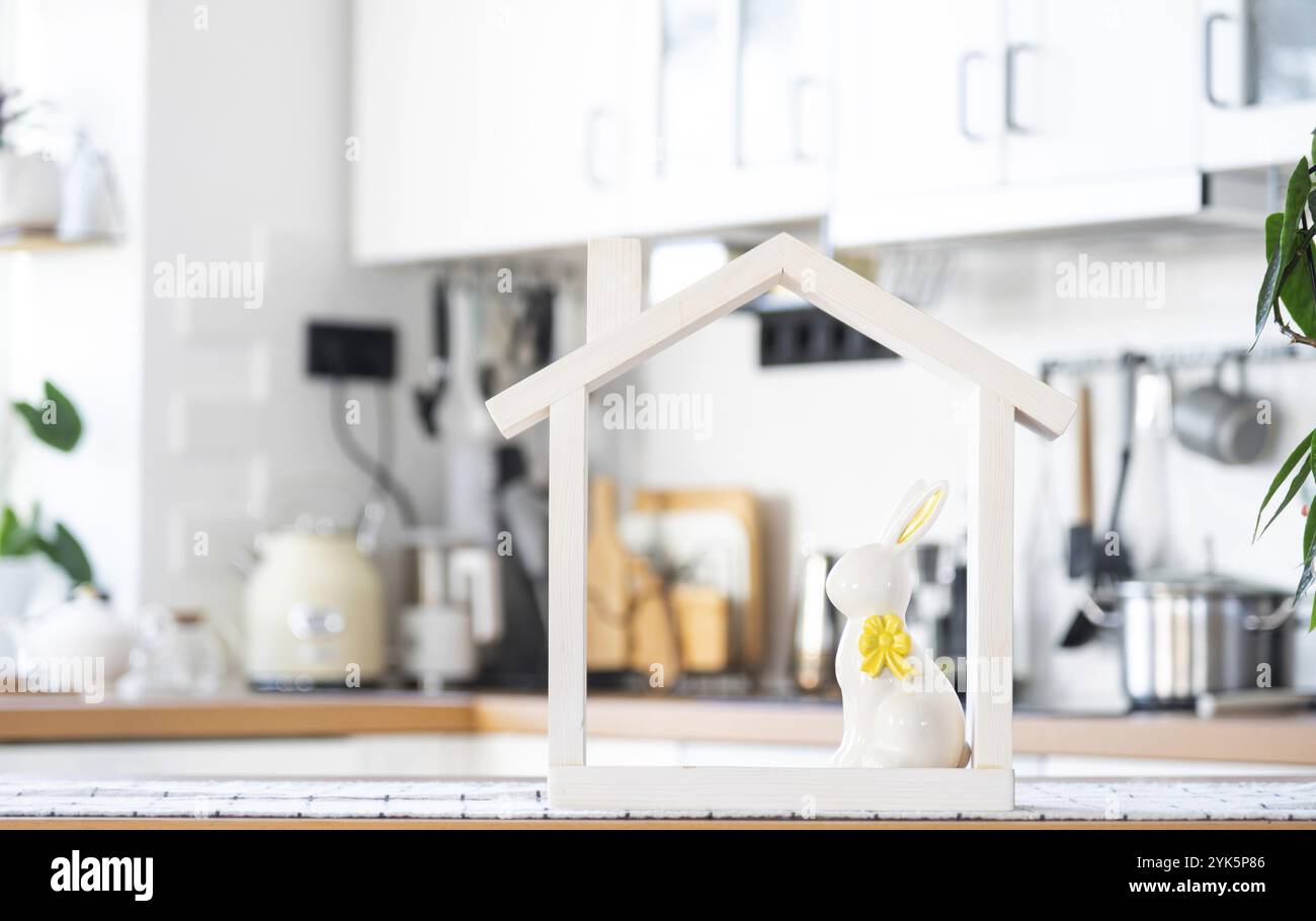 Tiny house of cozy home with Easter decor with rabbit and eggs on table ...