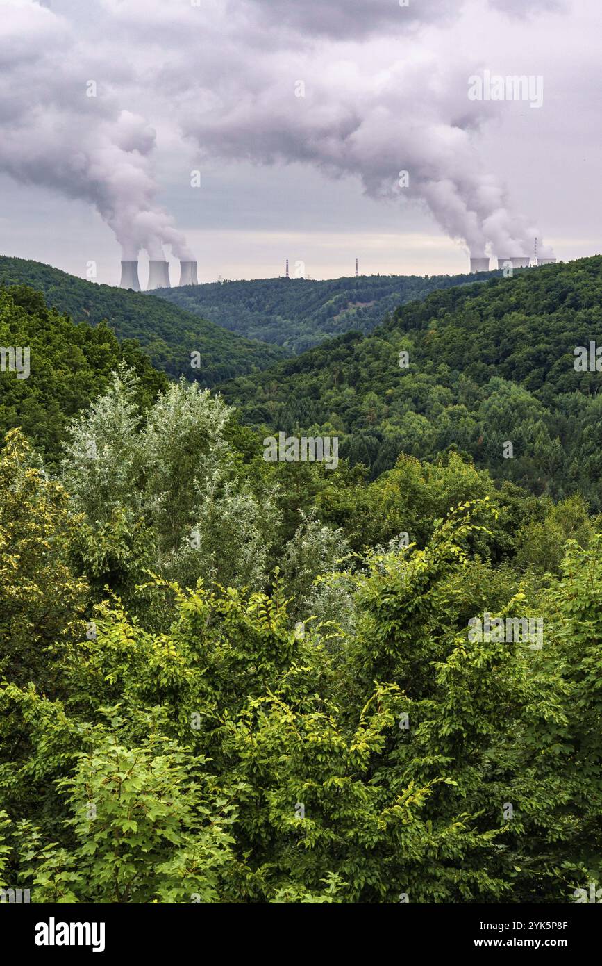 Valleys covered with forest and on the horizon are the cooling towers ...