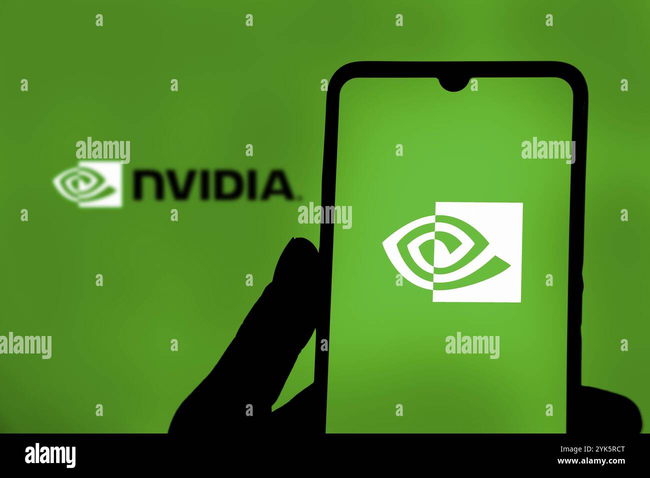 Nvidia logo on smartphone screen with AI in the background. Nvidia ...