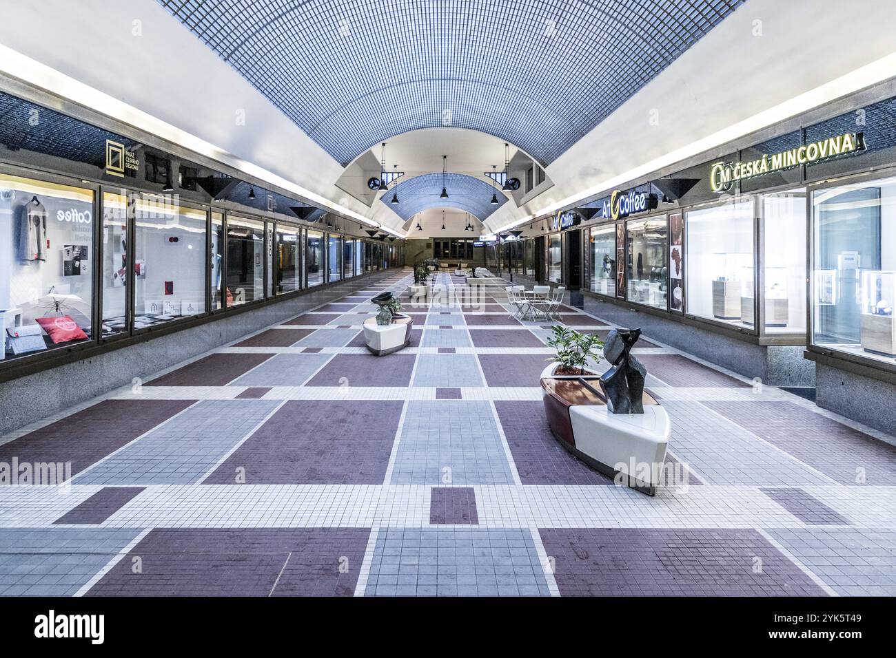 Modern shopping centre with blue ceiling and symmetrical architecture ...