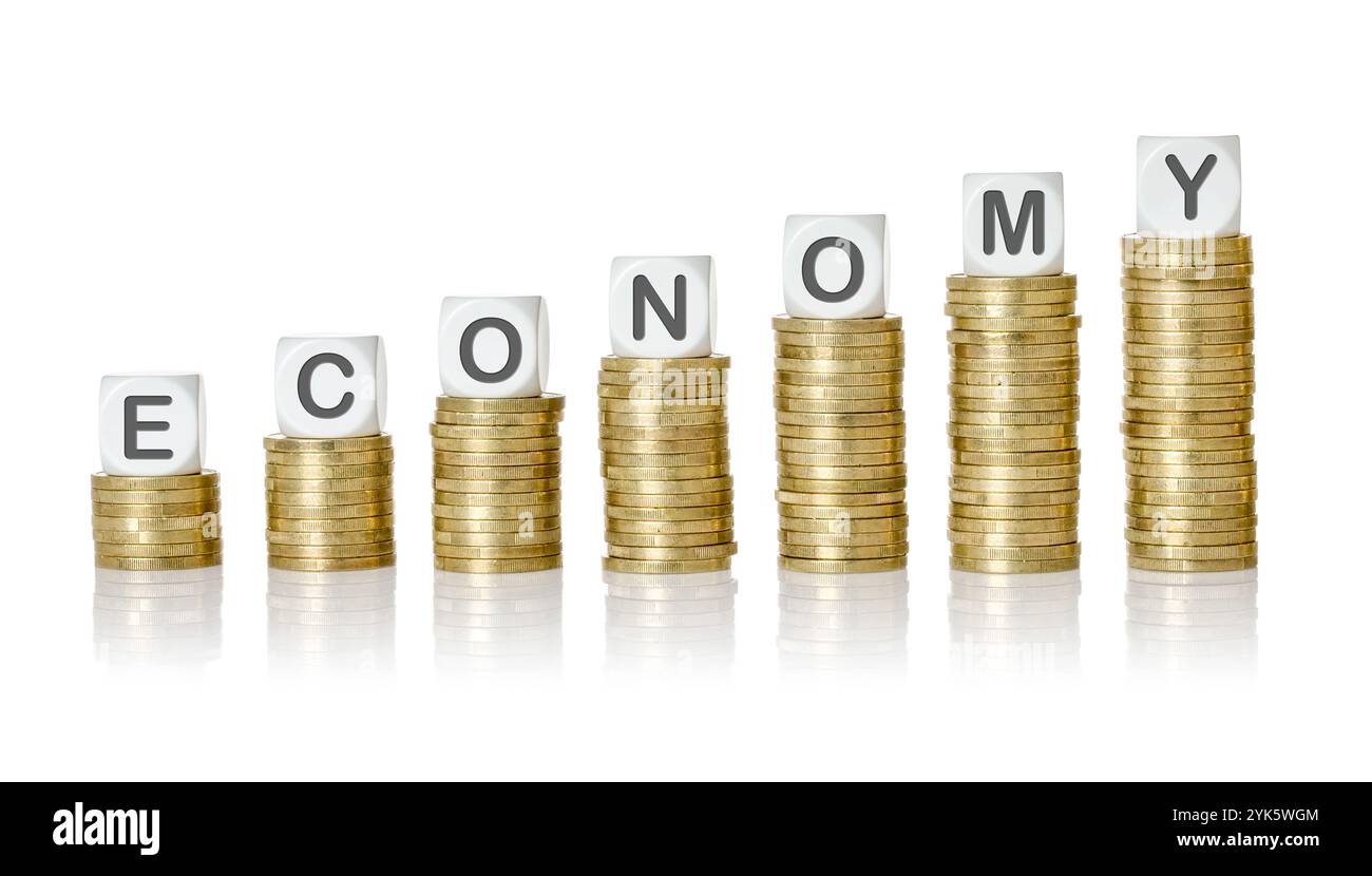 Coin stacks with letter dice - Economy Stock Photo - Alamy