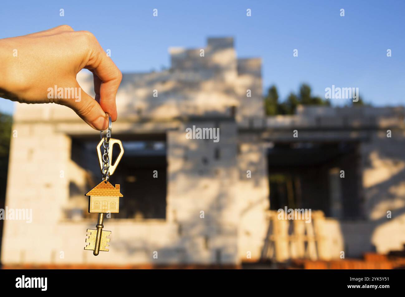 Hand with the key to the future house on the background of a ...
