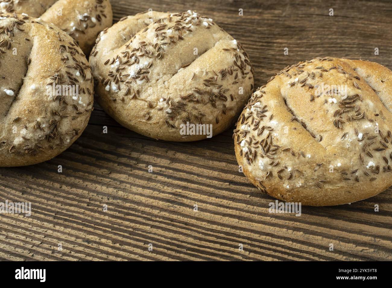 Bread rolls sprinkled with salt and caraway. Bakery assortment of bread ...