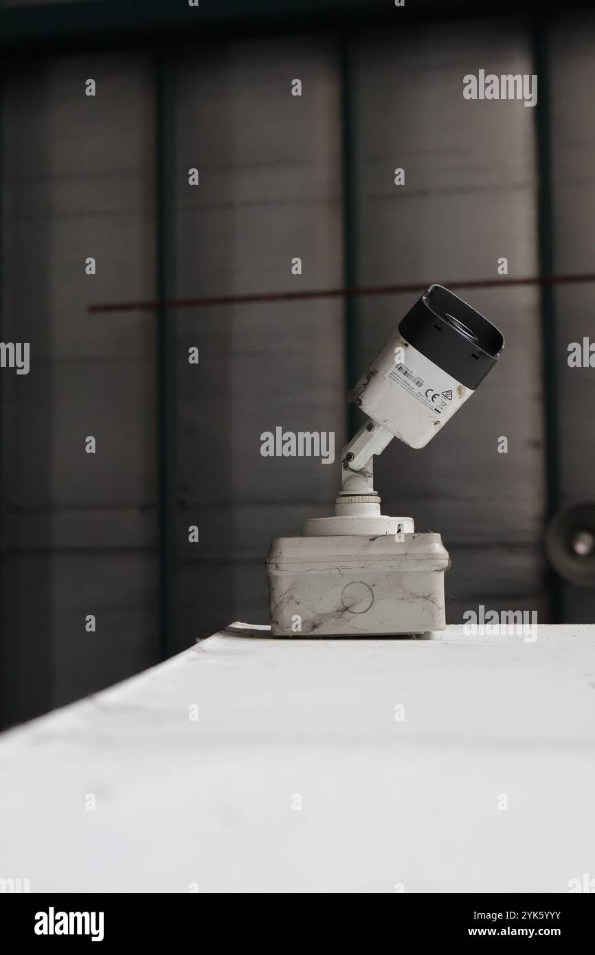 Close-up of a mounted CCTV security camera inside a warehouse ...