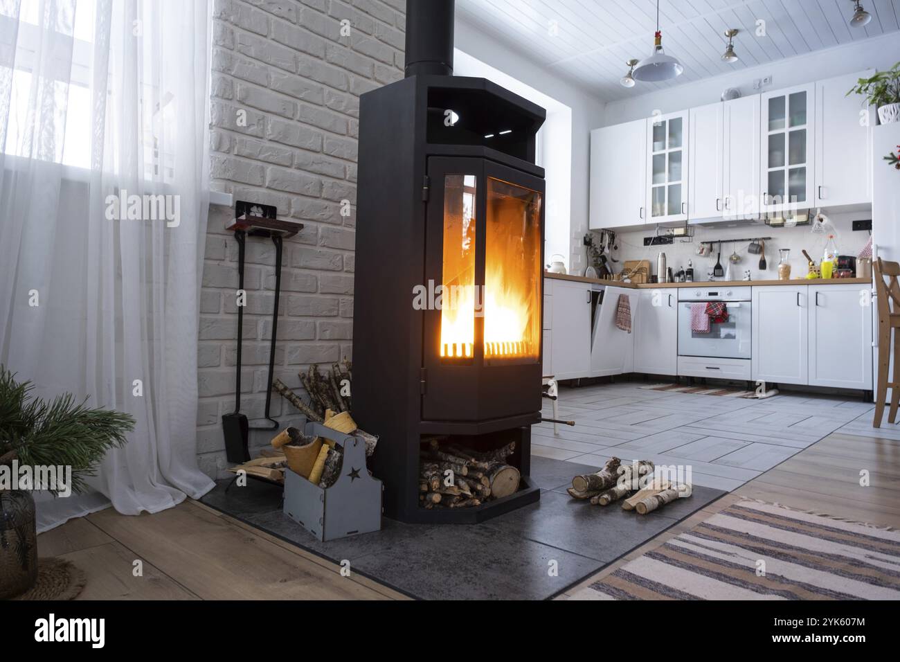 Black stove, fireplace in interior of house in loft style. Alternative ...