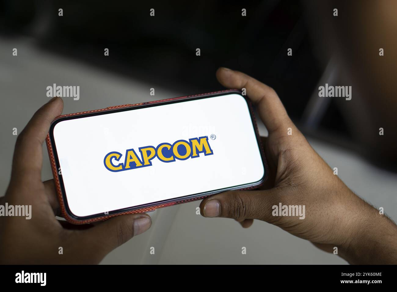 Capcom logo is displayed on smartphone.Capcom is a Japanese video game ...