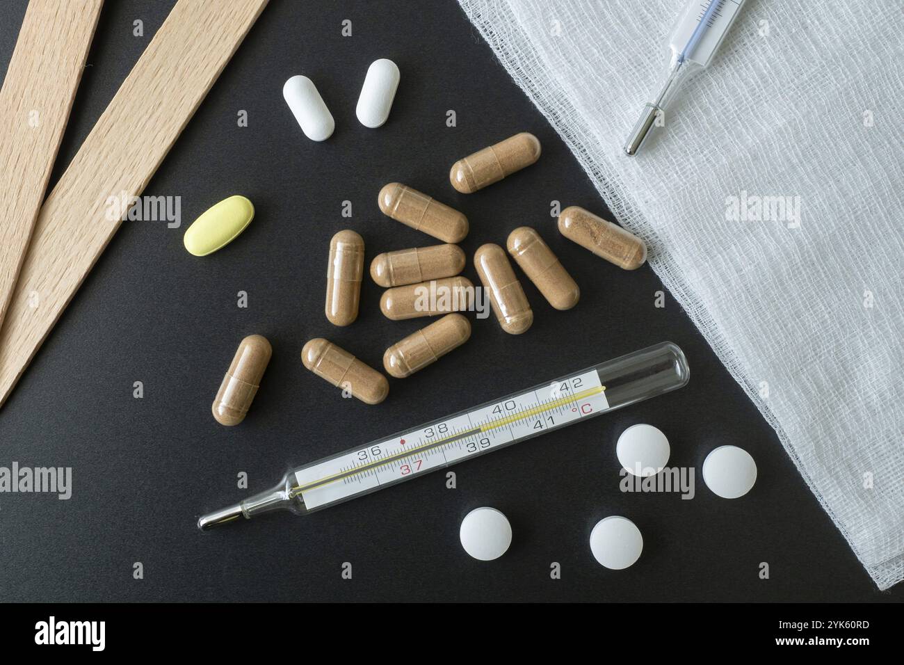 Traditional medical thermometer for measuring body temperature. Pills ...