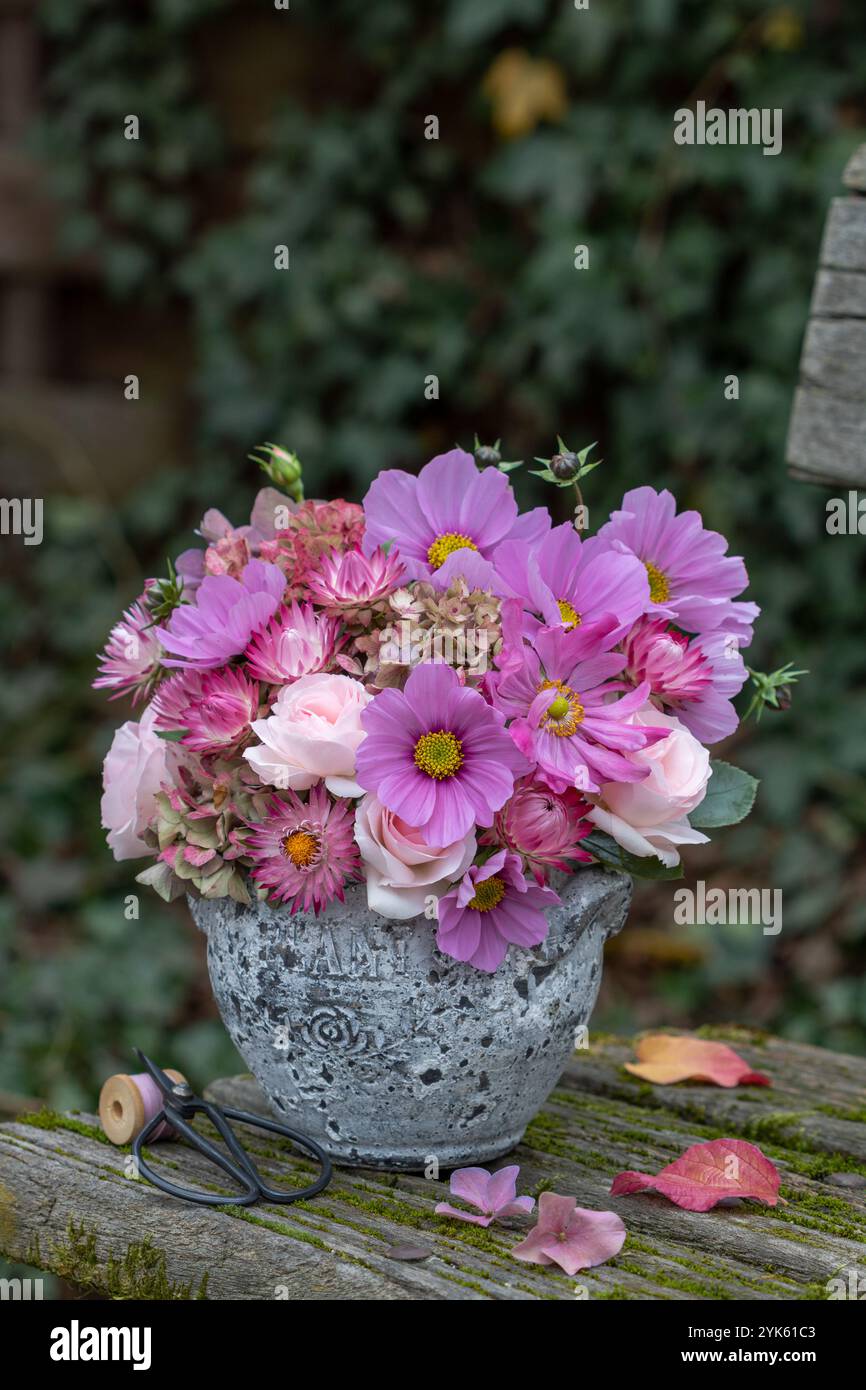 flower arrangement of pink cosmos flowers, roses, strawflowers ...