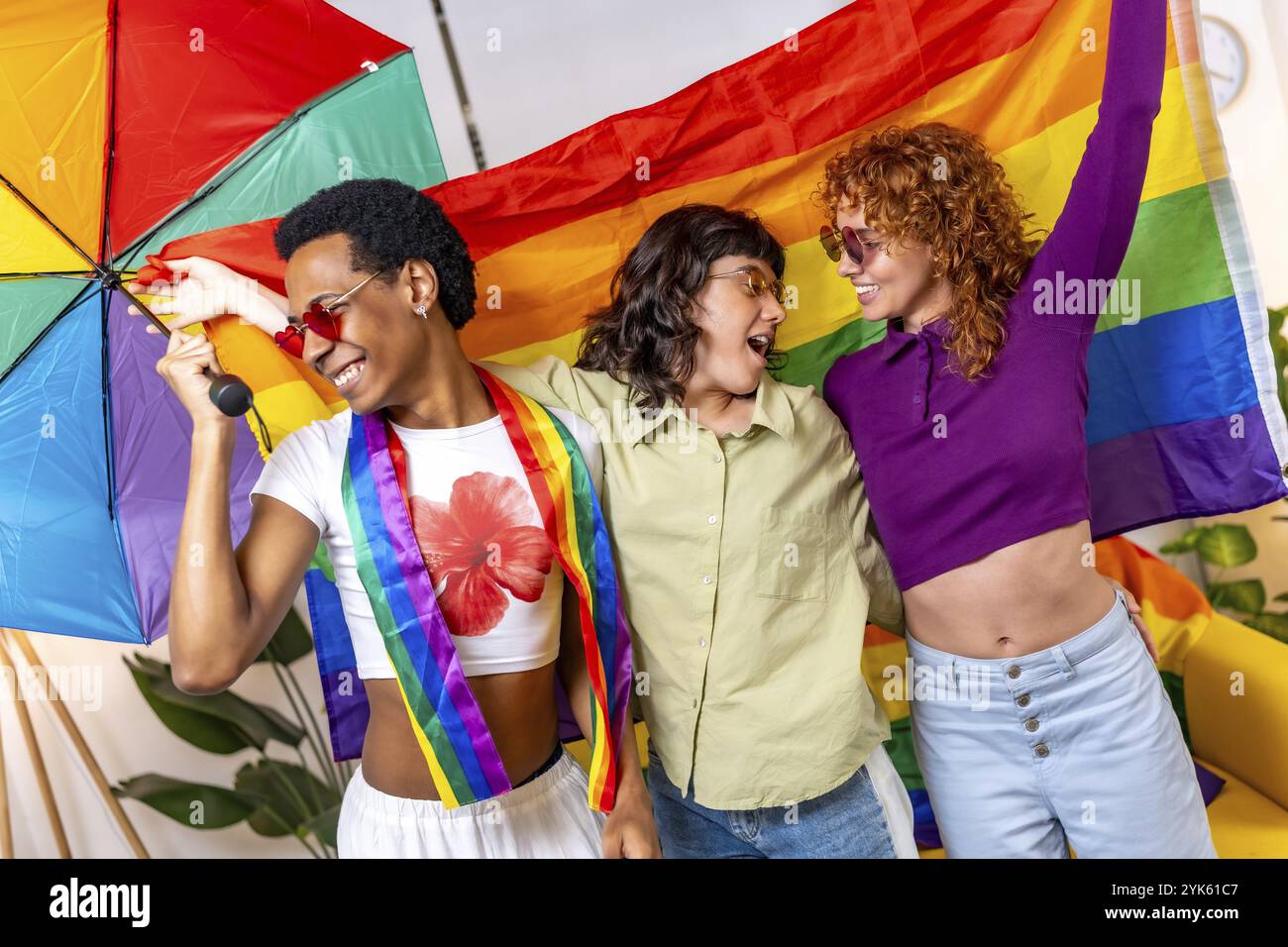 Multi-ethnic friends waving lgbt rainbow flag and dancing partying at ...