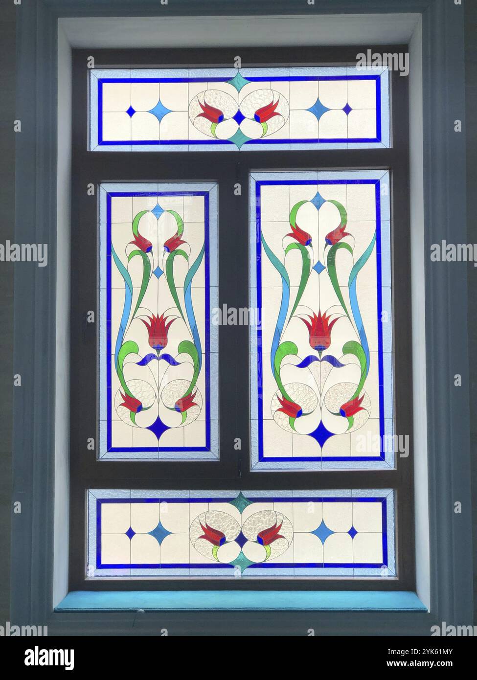 A stained glass window with colorful, symmetrical floral patterns Stock ...