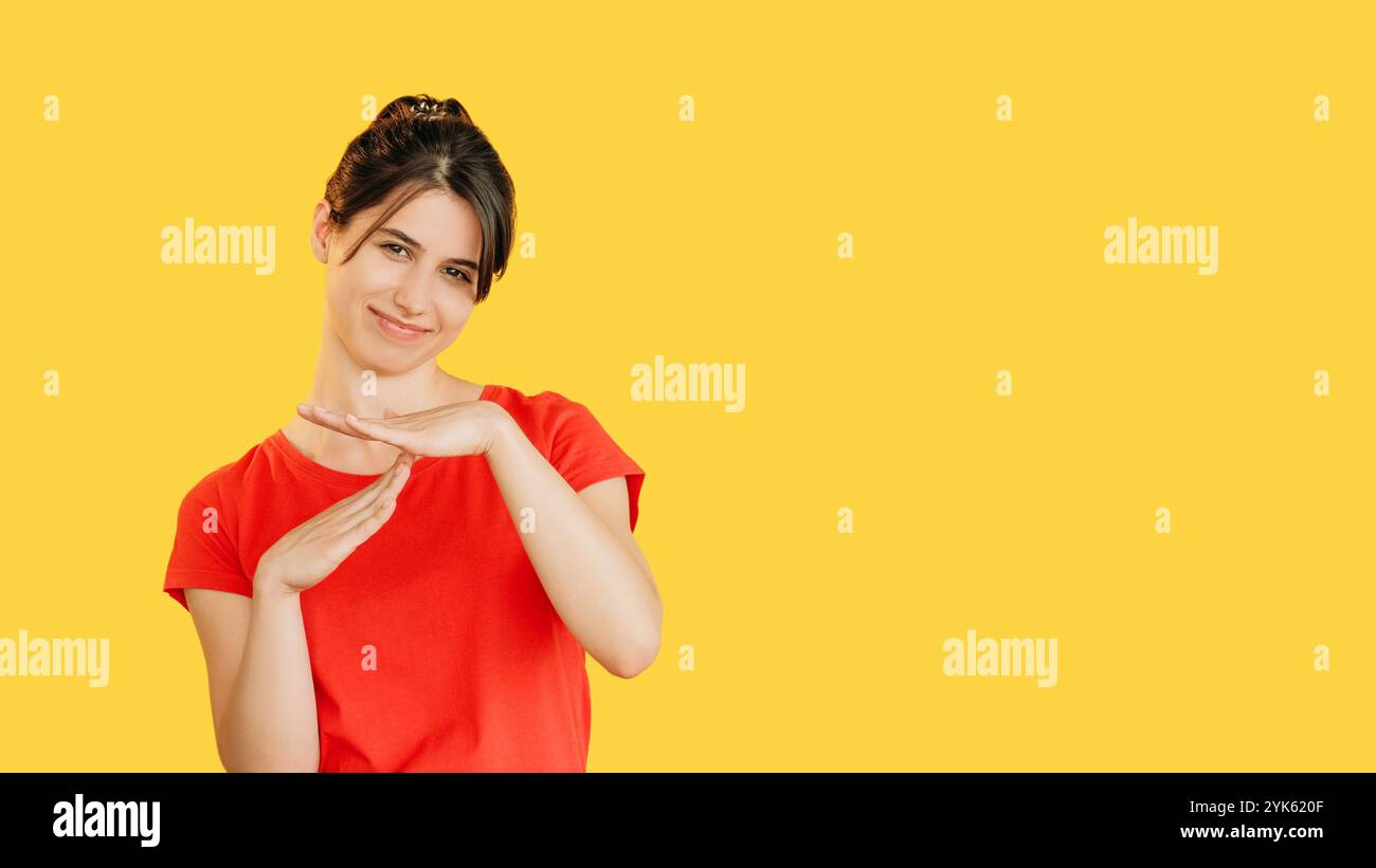 Stop gesture. Time out. Skeptic smiling woman in red showing break sign ...